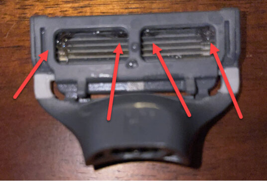 Long hair stuck between razor blades from my very first shave. Picture ...